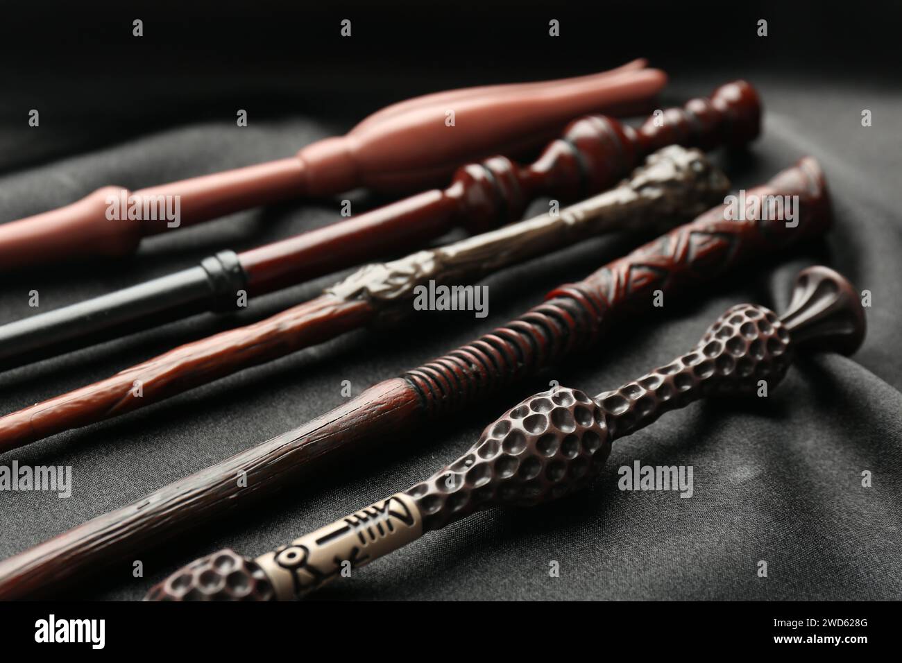 Different magic wands on black fabric, closeup view Stock Photo - Alamy