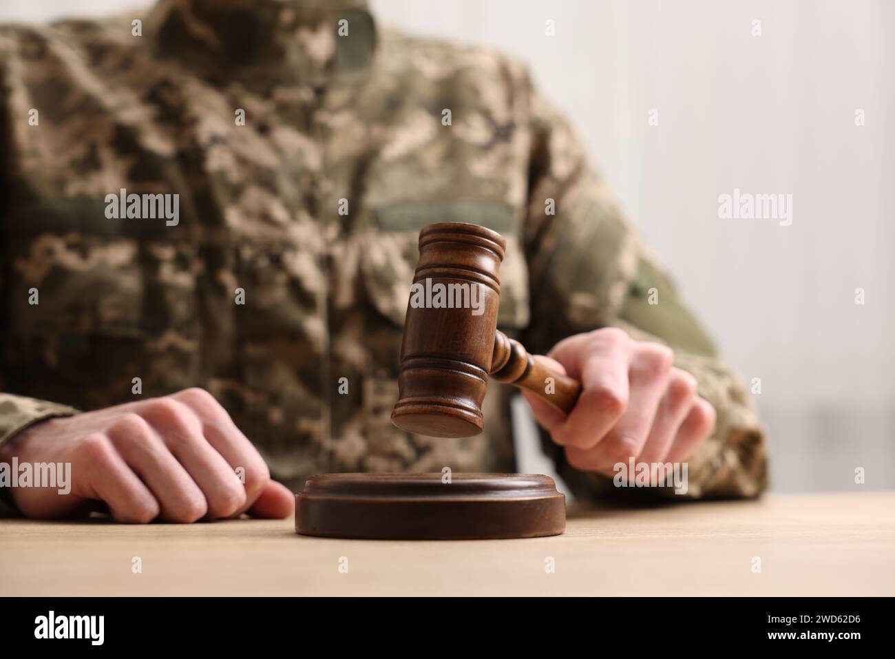 Law concept. Man in military uniform with gavel at table, closeup ...