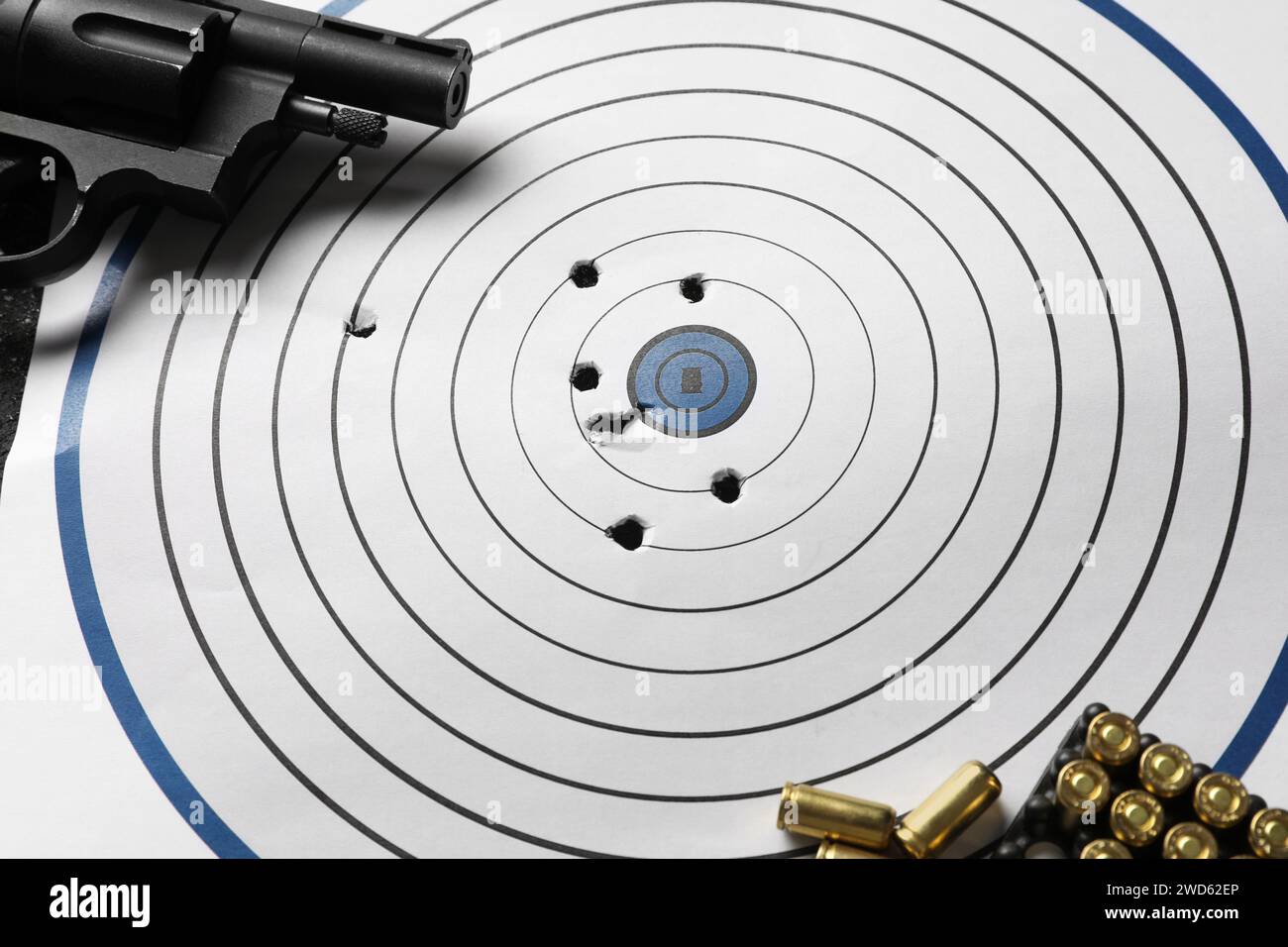 Handgun and bullets on shooting target, closeup Stock Photo - Alamy