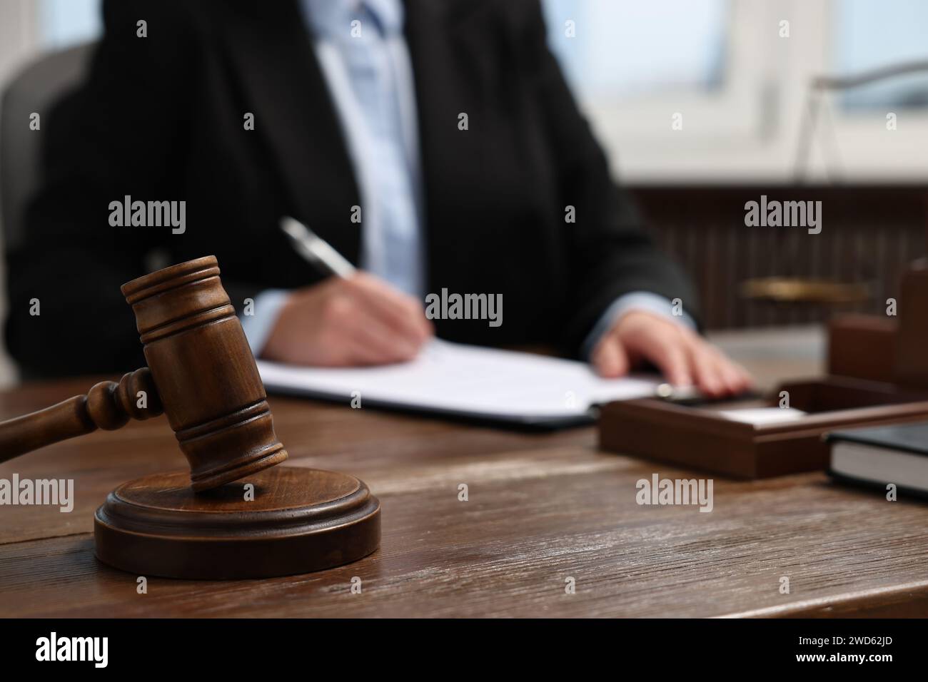 Lawyer working at wooden table in office, focus on gavel Stock Photo ...
