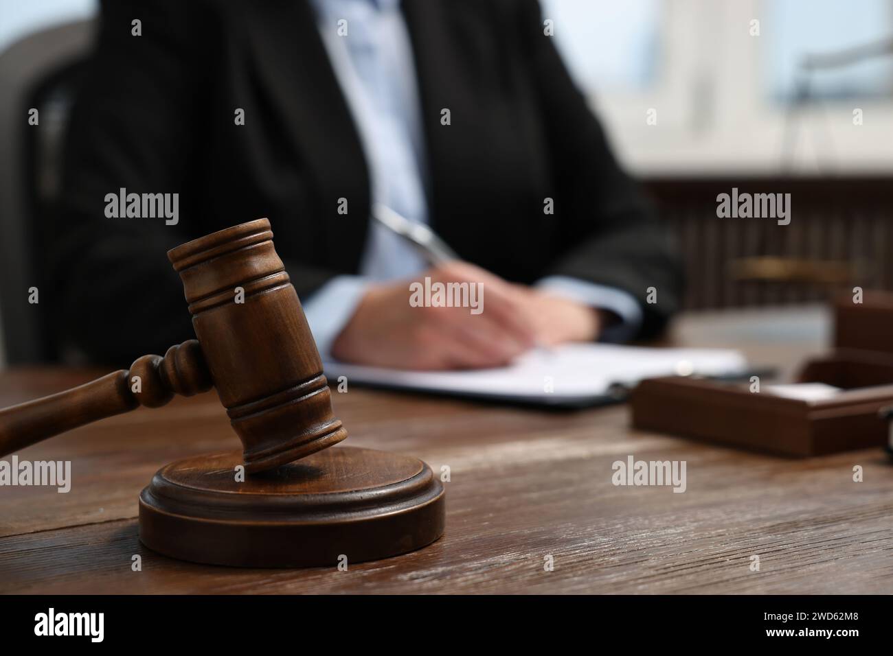 Lawyer working at wooden table in office, focus on gavel Stock Photo ...