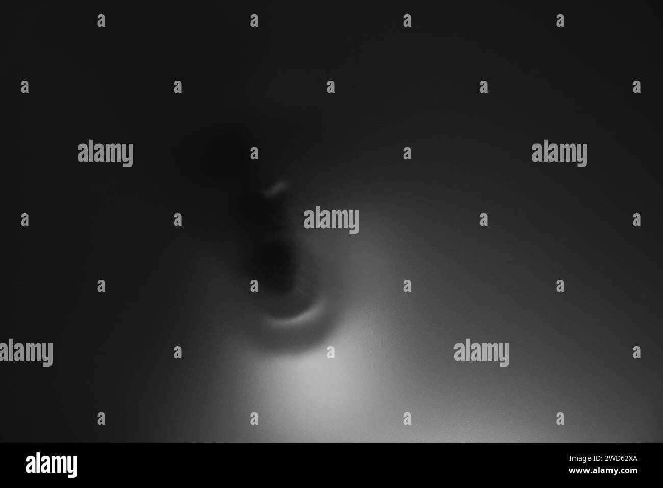 Silhouette Of Creepy Ghost Behind Glass Against Grey Background Stock