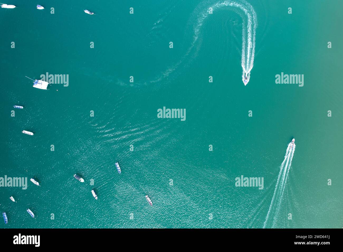 Small boats moving in blue sea water aerial above top drone view Stock ...