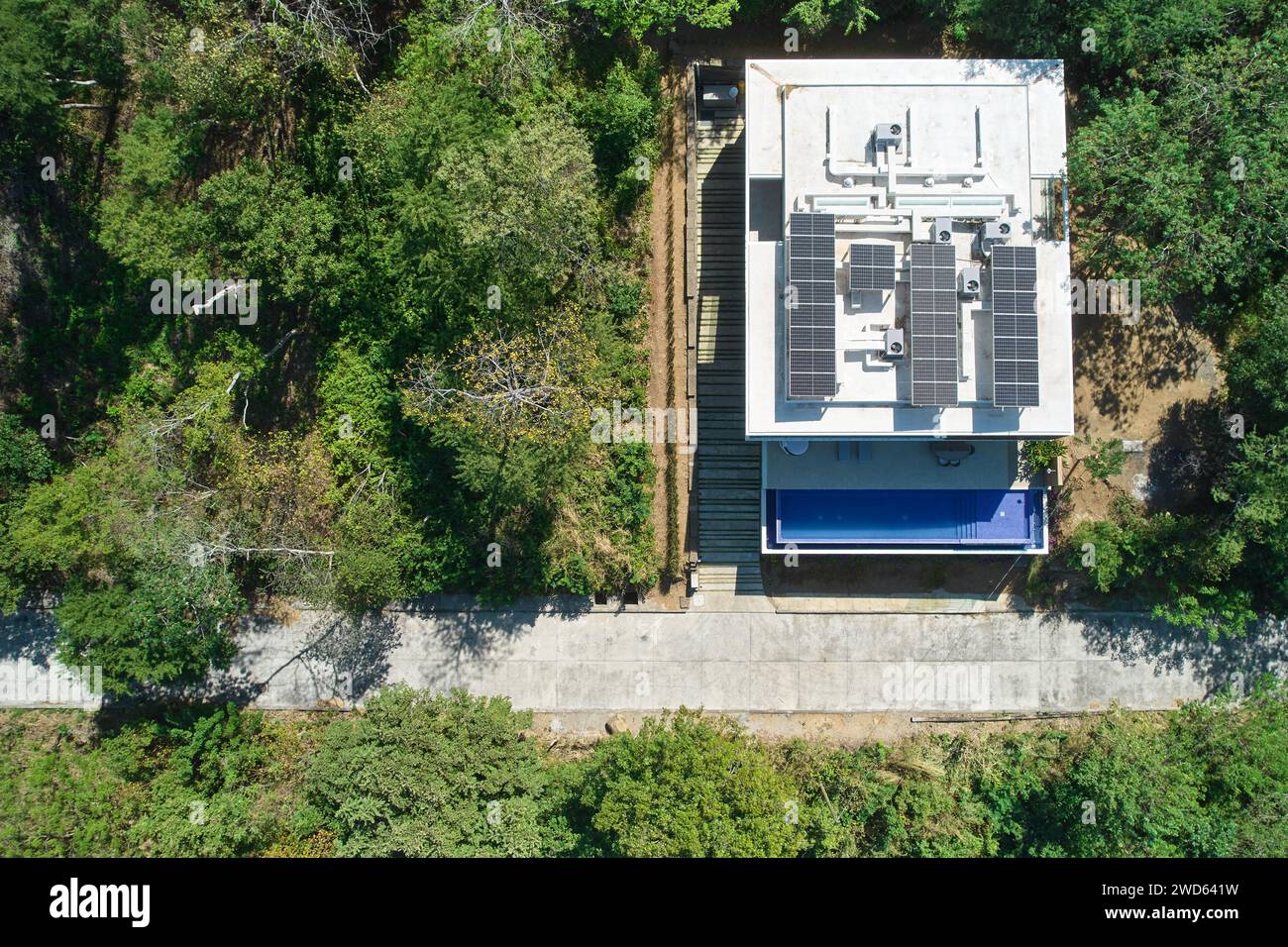 Modern house with solar panels and swimming pool above top aerial view ...