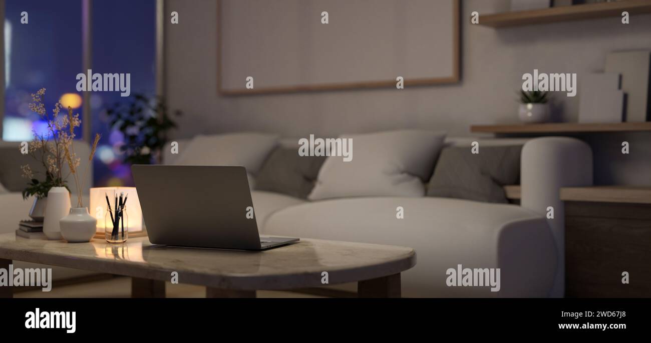 A laptop computer on a coffee table in a modern, cosy apartment living ...