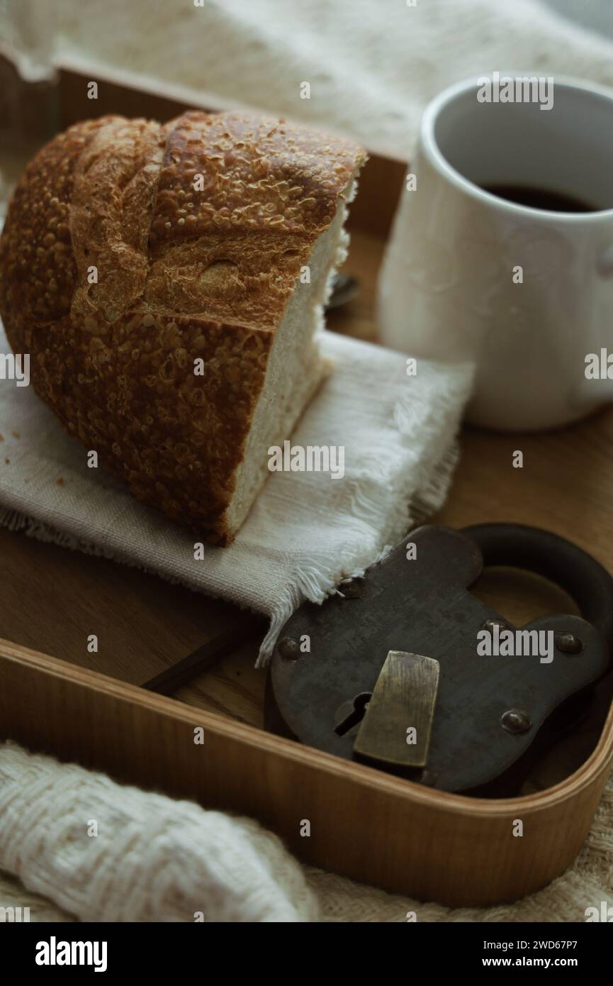Rustic Charm - crusty sourdough bread sits aside a cup of coffee on a ...