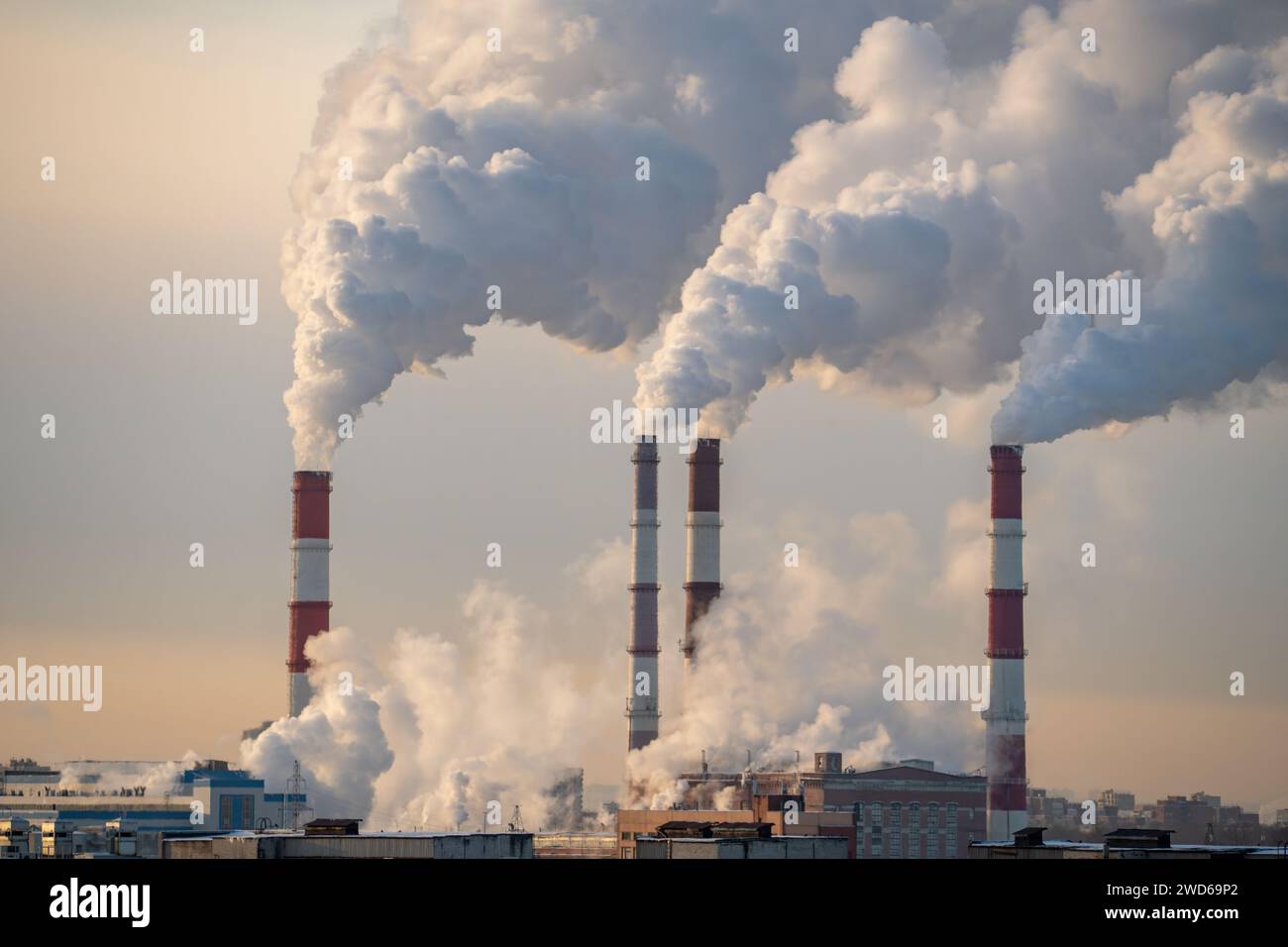 Smoke from factory pipe of heat station in winter time. Fuel oil or ...