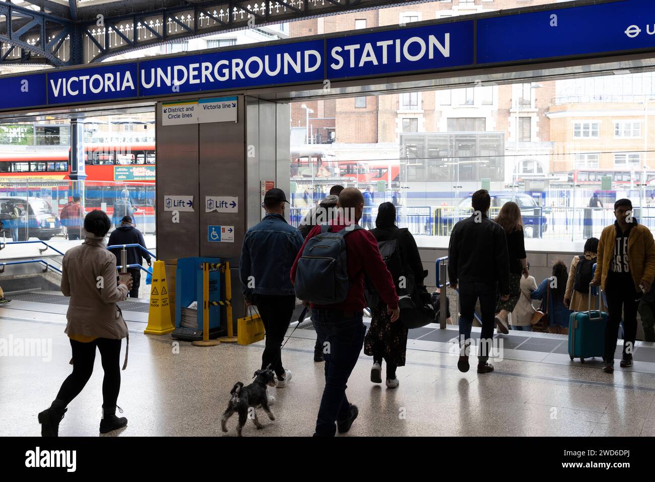 A busy entrance and exit to Victoria Underground Station with the ...