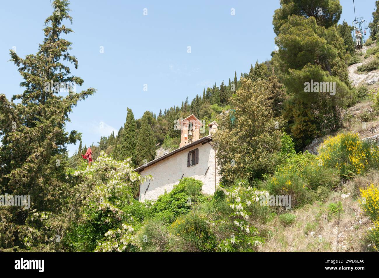 Small chapel with bell tower built in hillside of Mt Ingino above ...