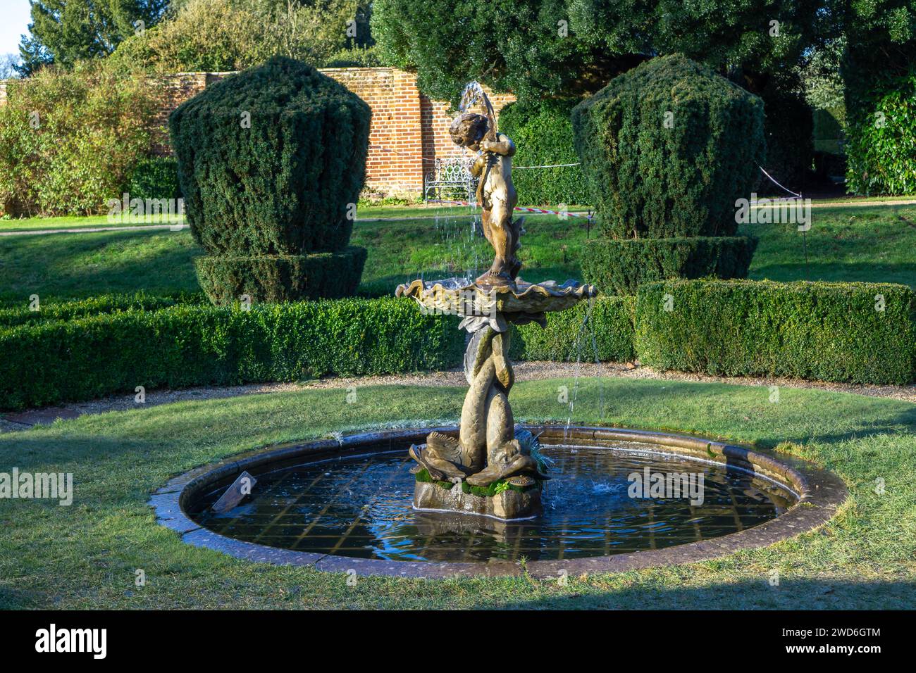 A classical stone fountain with a cherub statue in the Dutch Garden in ...