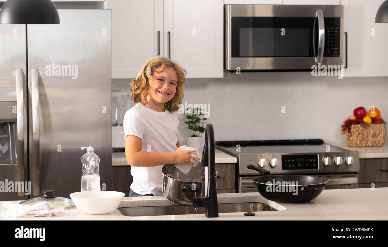 Boy washing plates hi-res stock photography and images - Alamy