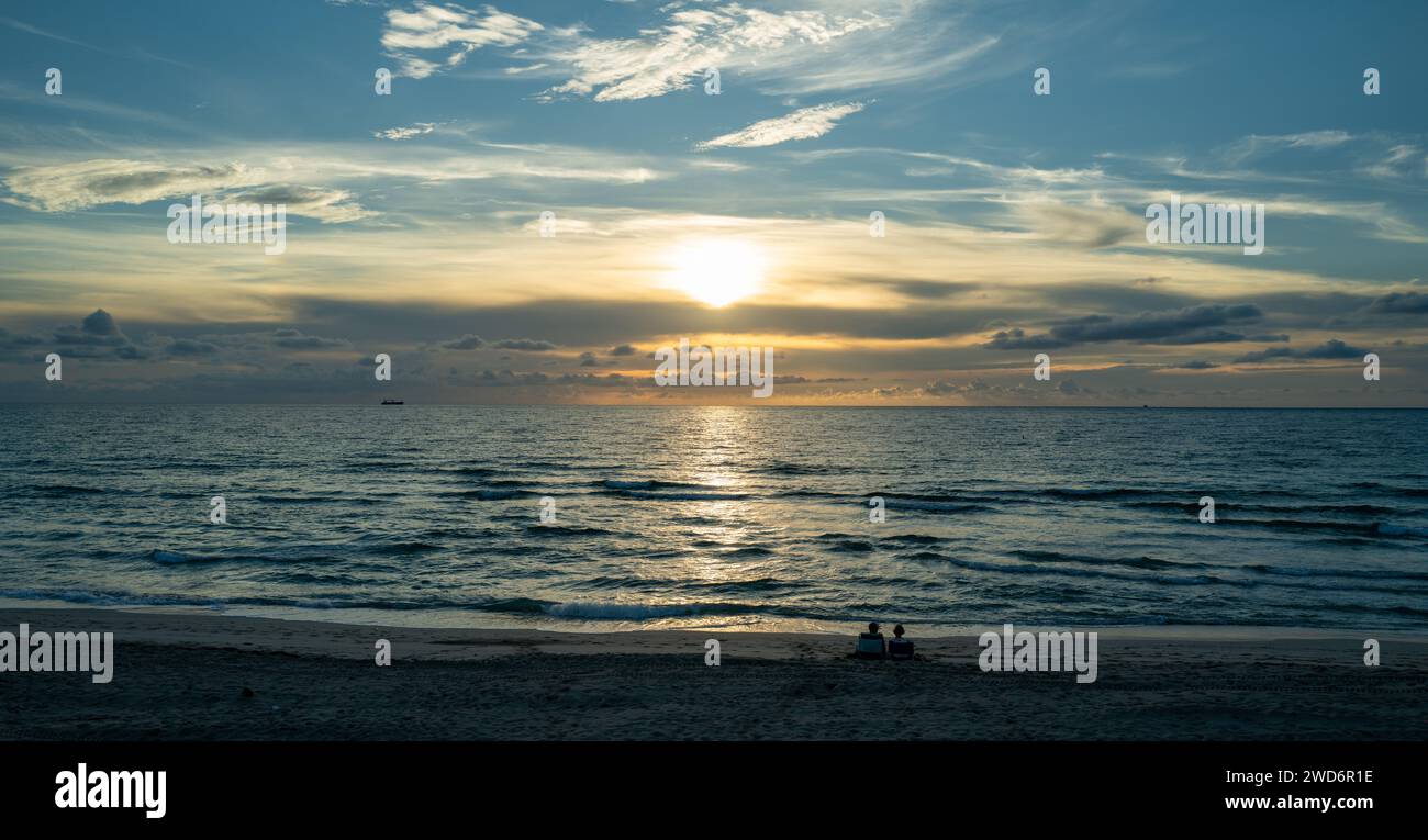 Sunset sea. Calm sea with sunset sky through the clouds over ...
