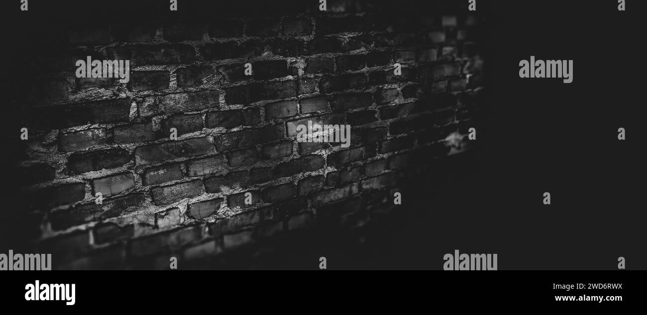 Dark, textured brick wall. Dark background, black and white, moody and ...