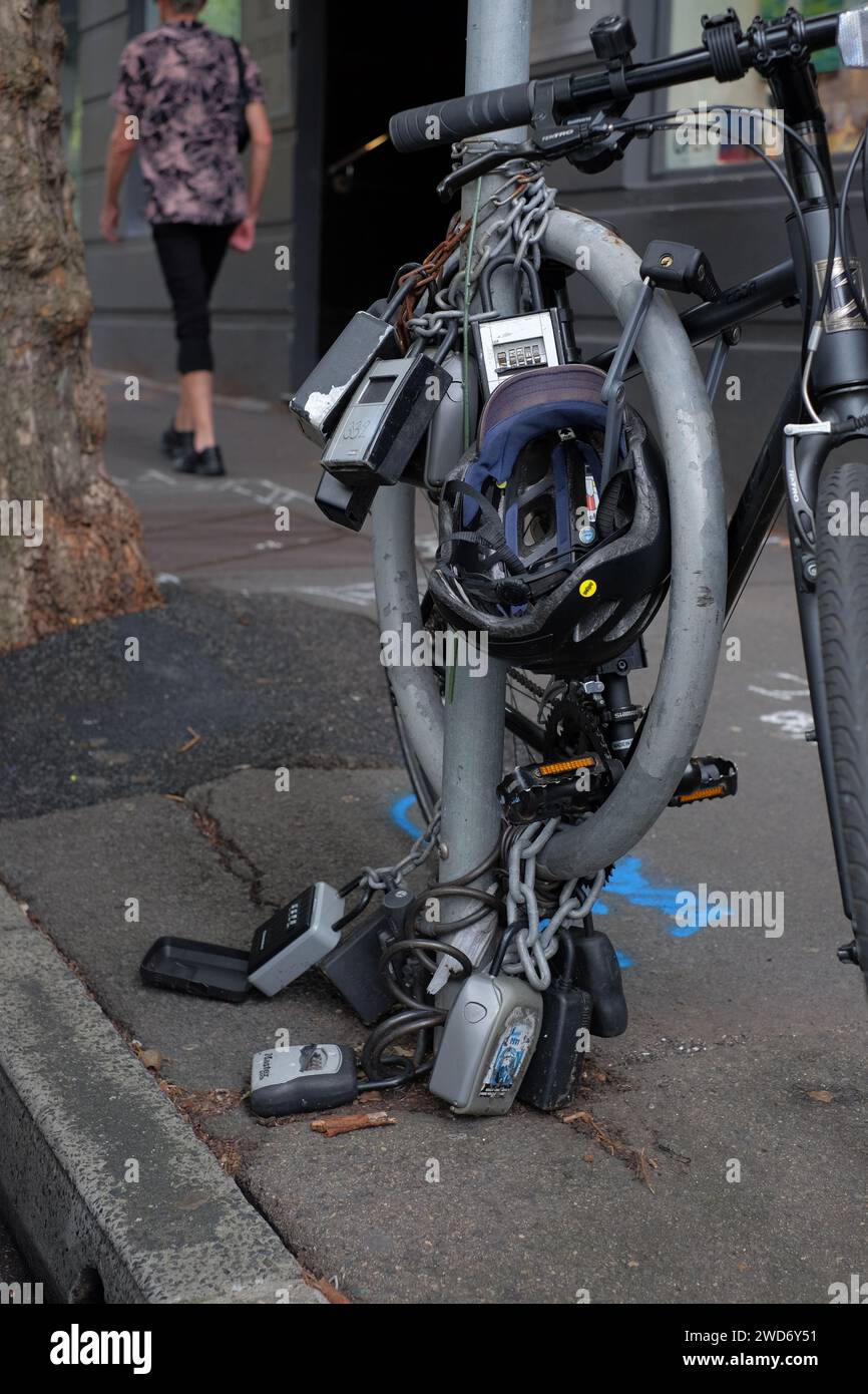 Combination locks, key boxes wrapped in chains around a metal post on ...