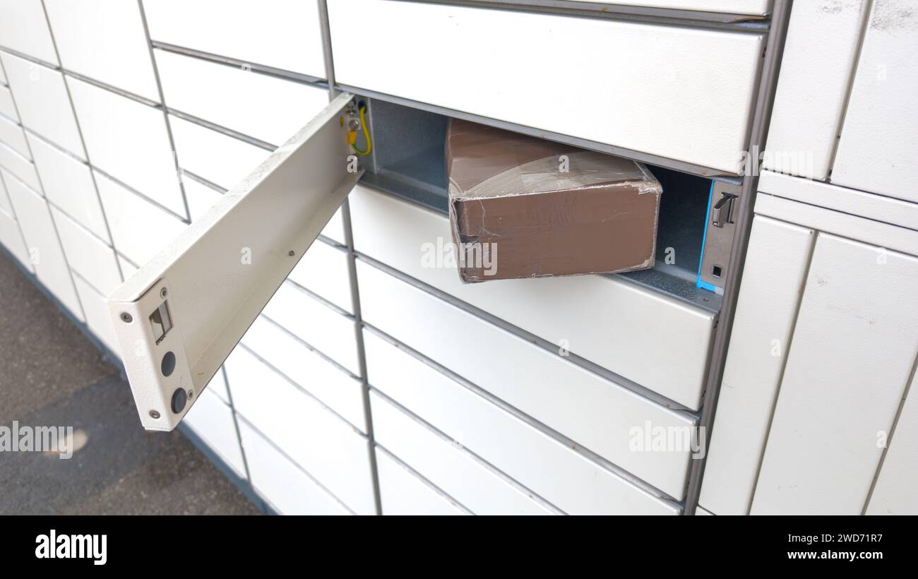 Modern parcel locker with many postal boxes outdoors and open box with ...
