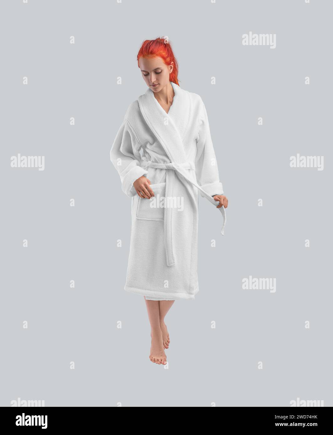 Mockup of a white terry bathrobe on a red-haired girl in full length ...