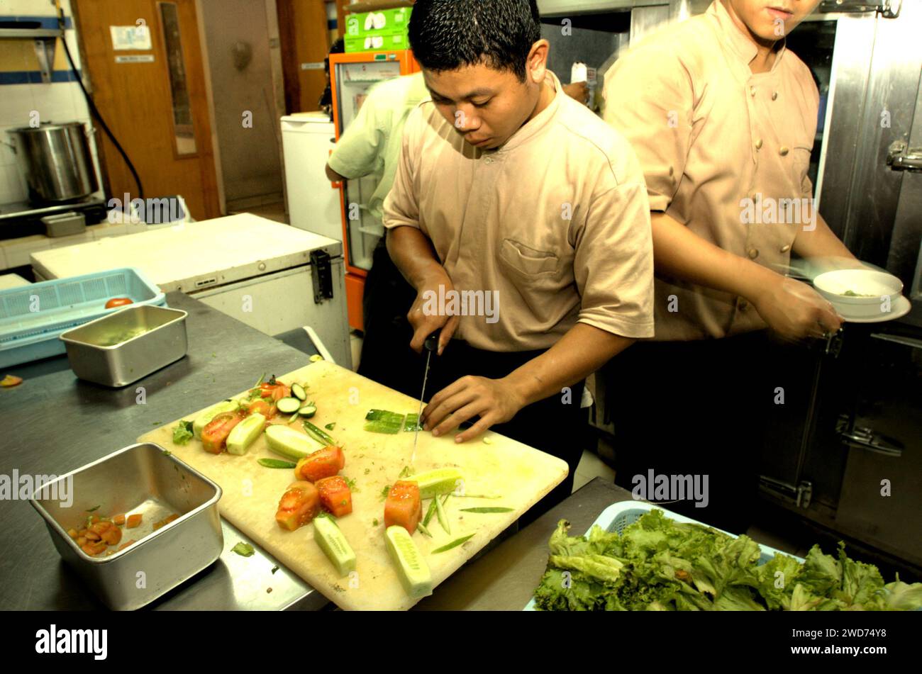 Chefs prepare halal foods at the kitchen of an Islamic cafe managed by ...