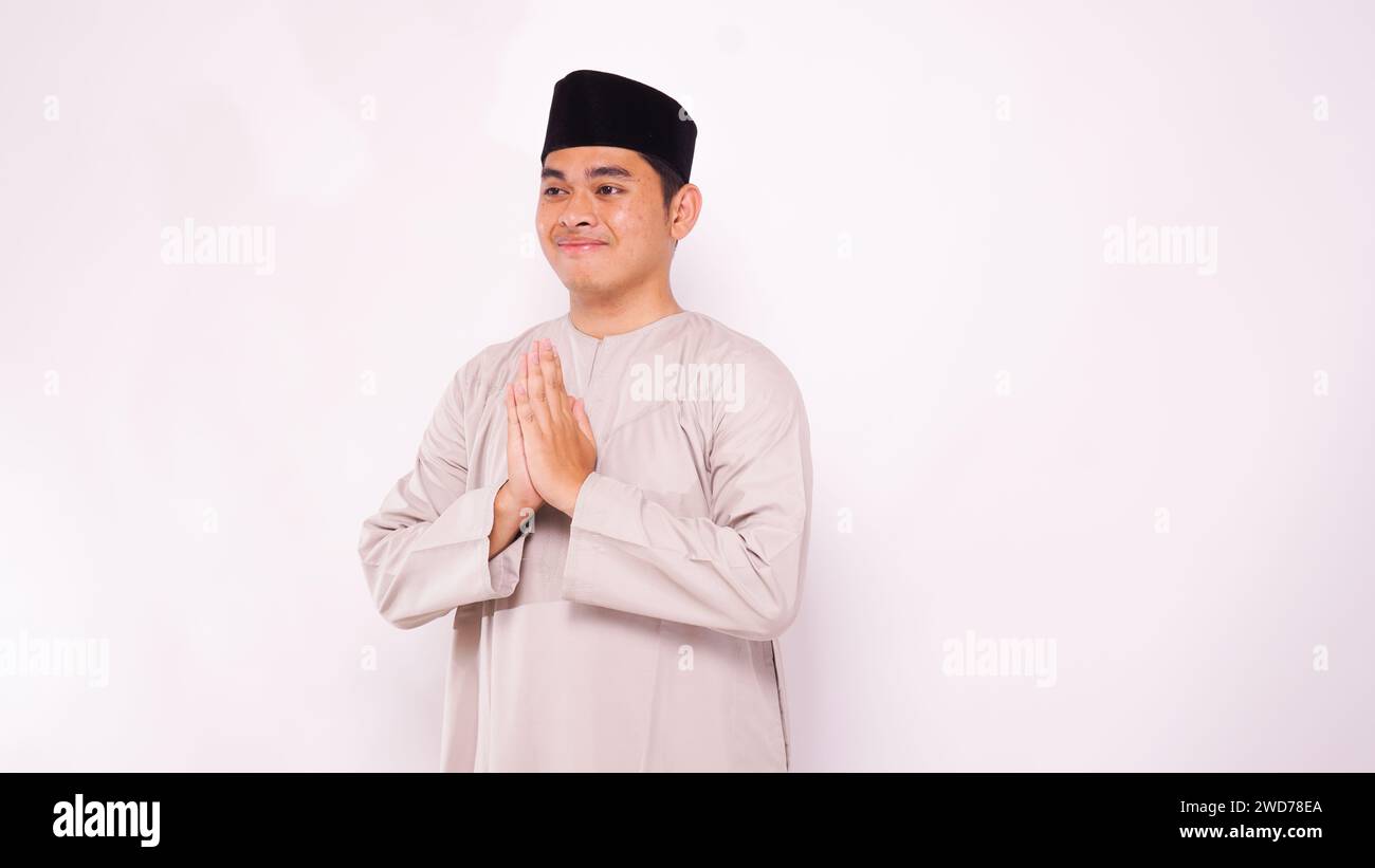 Asian Muslim man smiling to give greeting during Ramadan and Eid Al ...