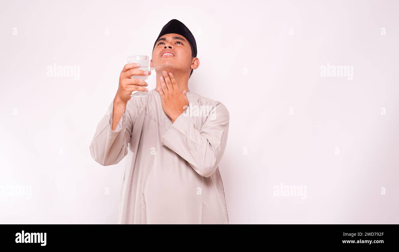 Asian muslim man break the fasting with drinking water during month of ...