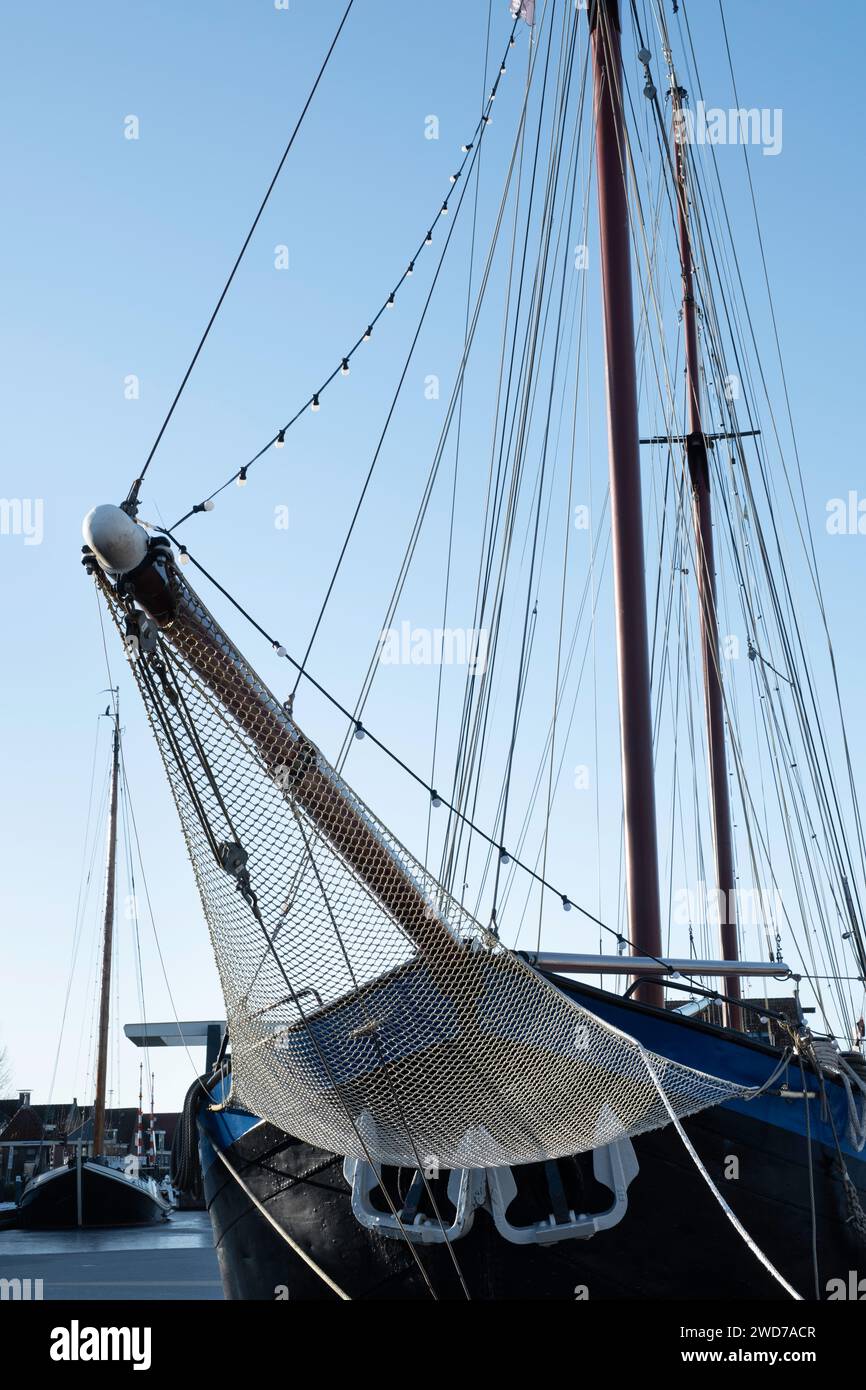 Ship's bow with jib boom and tightly knotted jib net in front of the ...