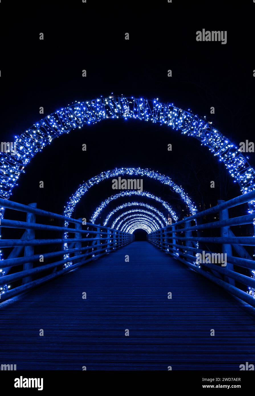 A blue-illuminated bridge leading to the entrance Stock Photo - Alamy