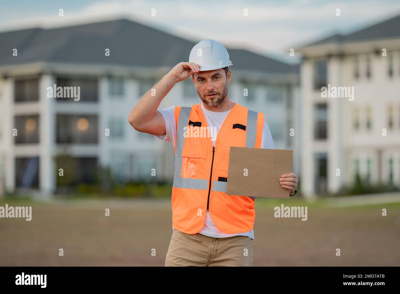 Engineer hold paper board for text. Builder showing signboard placard ...