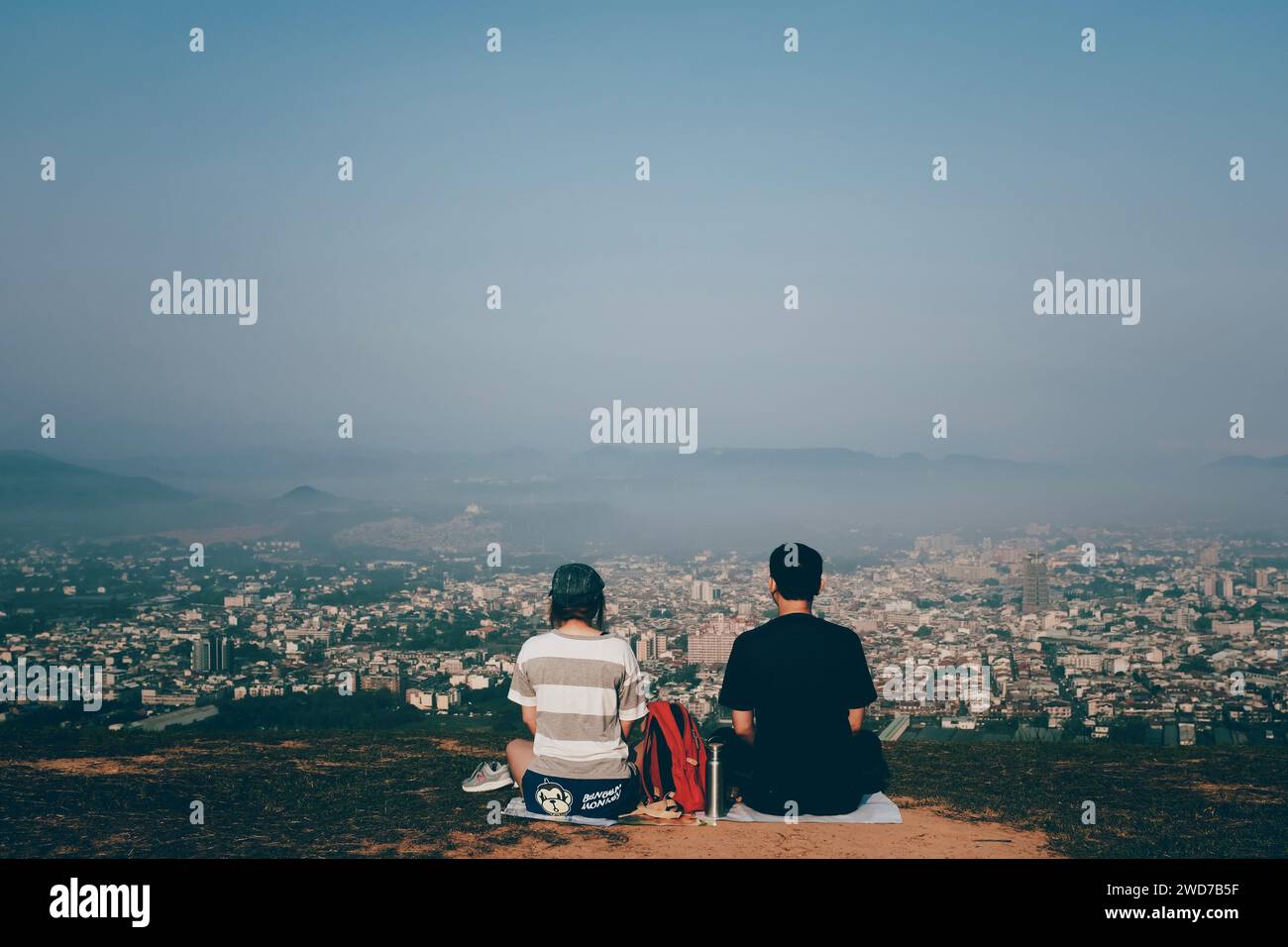 People meditate on top of a mountain overviewing the city Stock Photo ...
