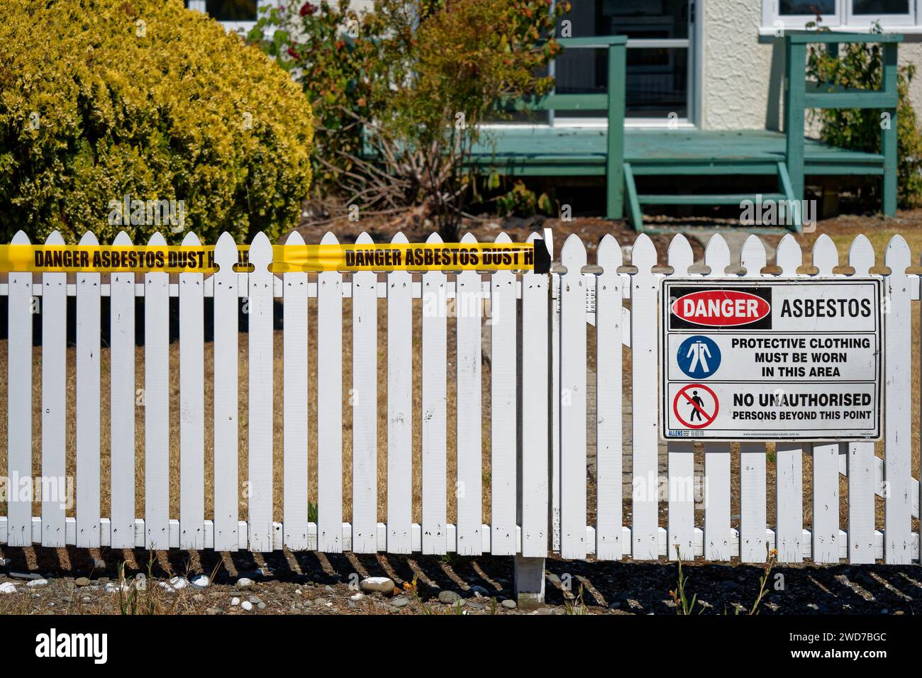 Warning signage about asbestos dust hazard outside a property in ...