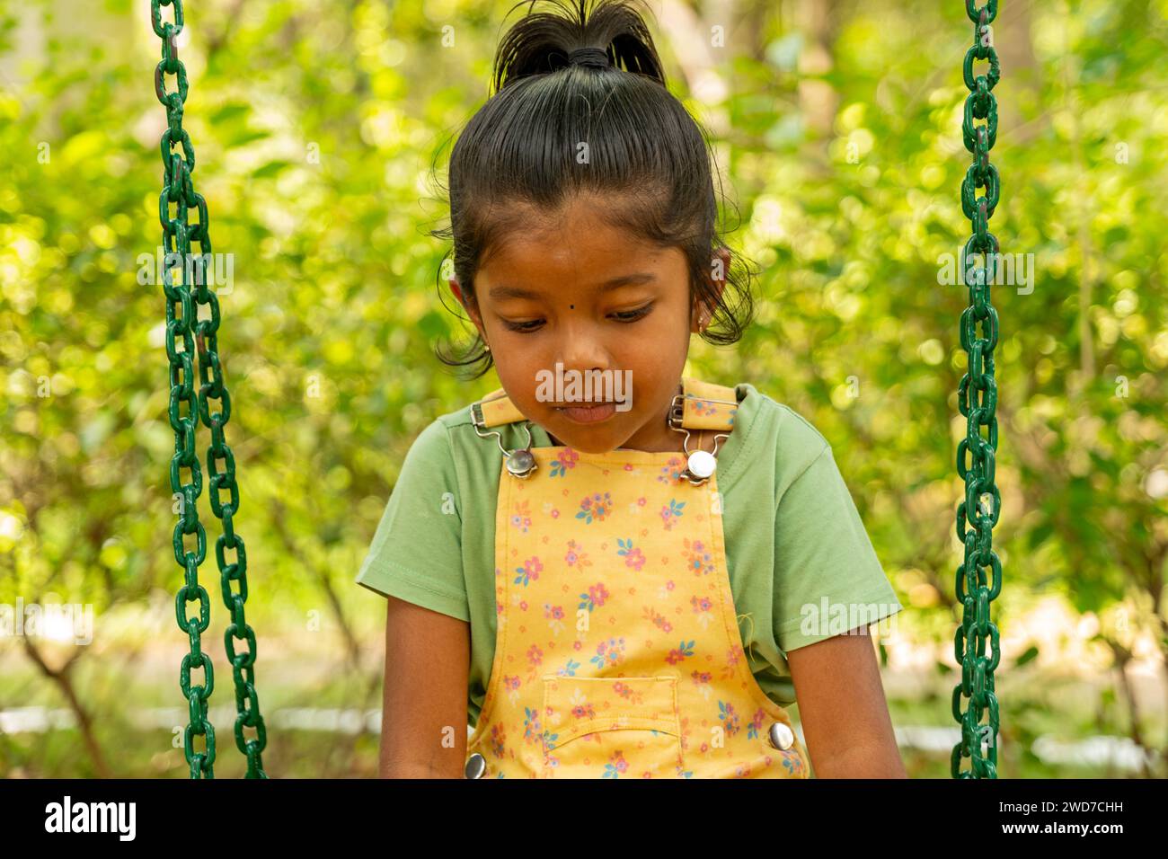 Capturing the poignant moment of a young girl sitting forlornly on a ...