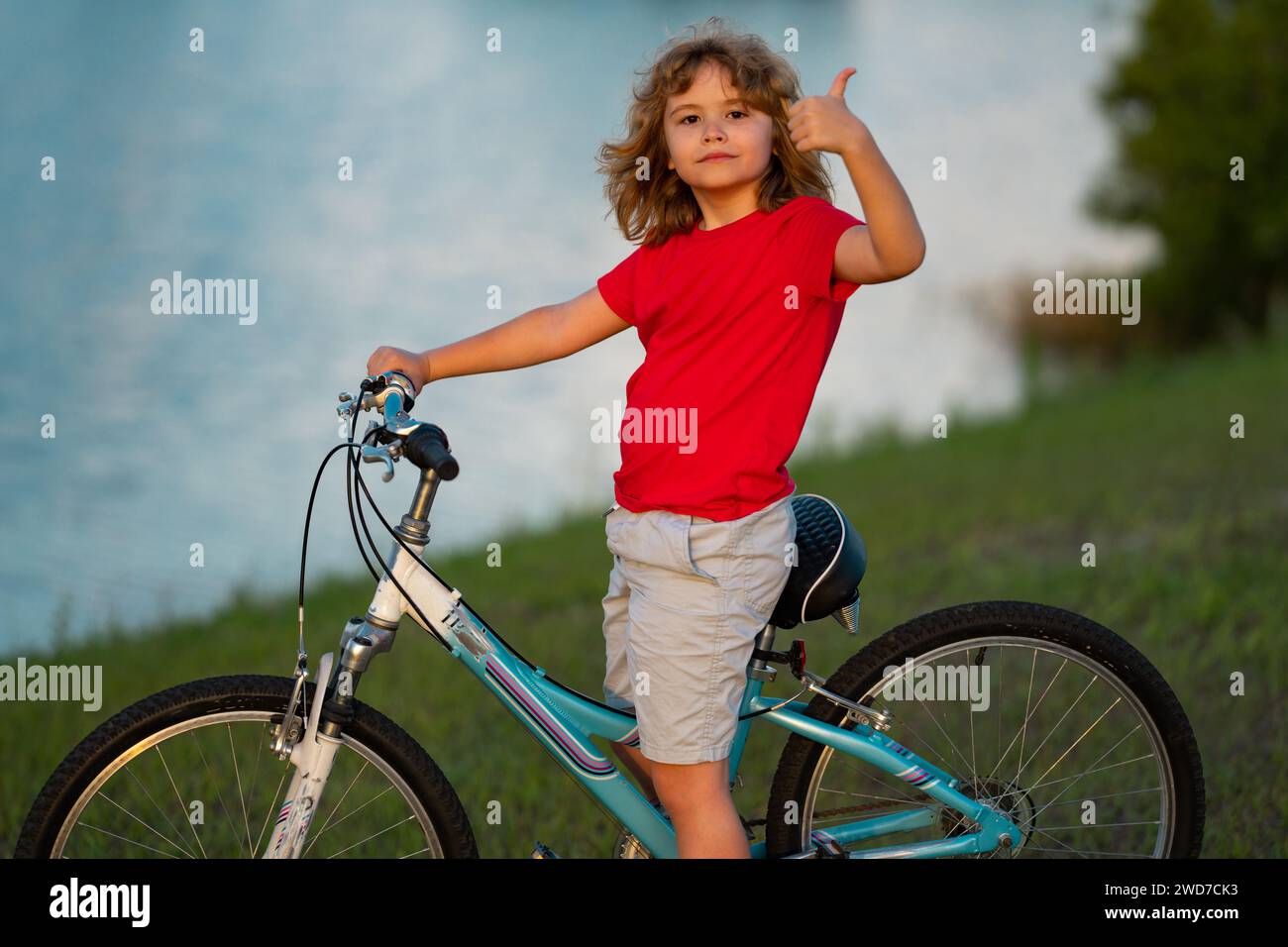 Little kid boy ride a bike in the park. Kid cycling on bicycle. Happy ...