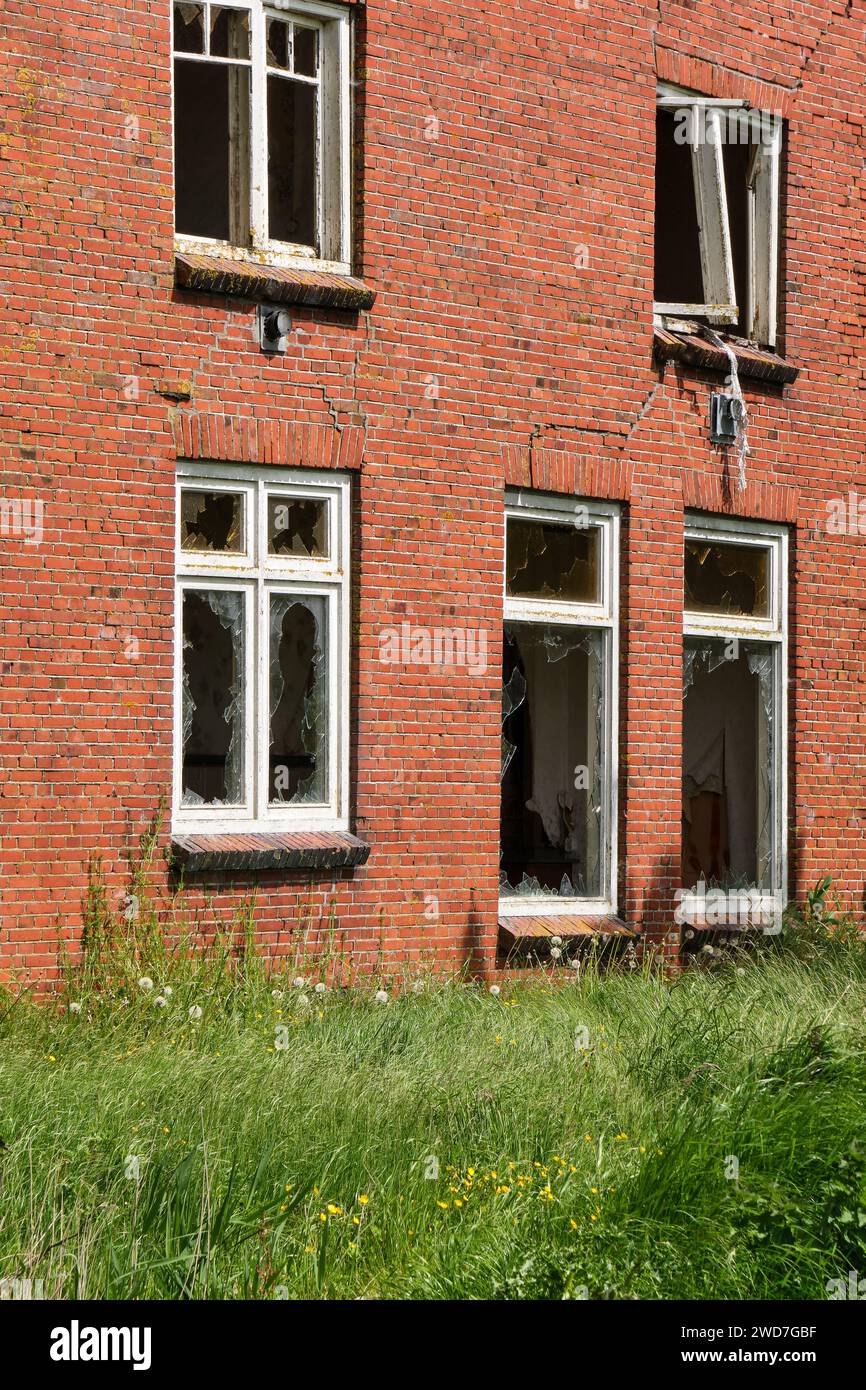 Closeup of an abandoned and dilapidated farm house with red bricks and ...