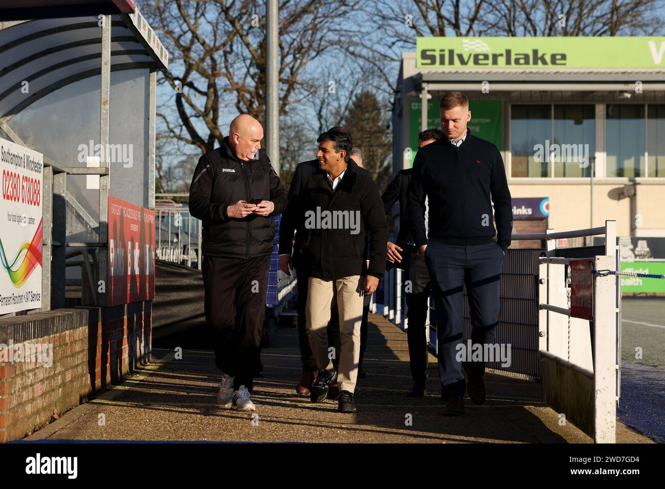 Prime Minister Rishi Sunak walks with Richard Hill (left), manager of ...