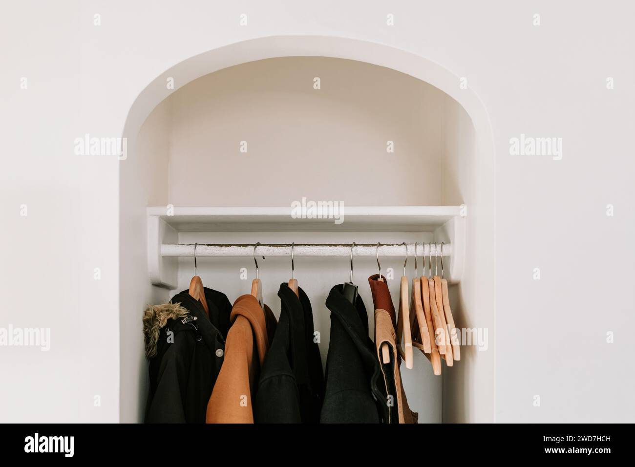 Winter coats and jackets hanging in the closet at home Stock Photo - Alamy