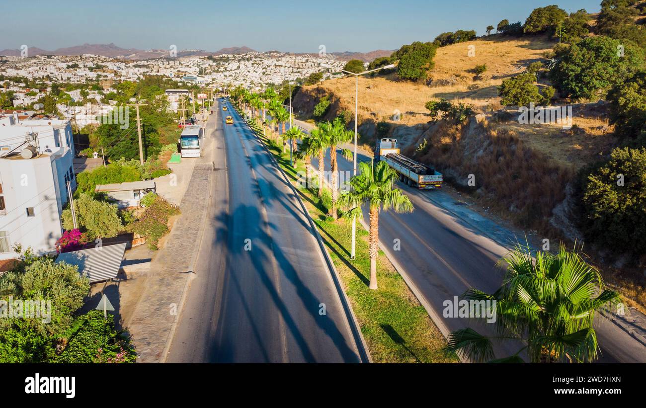 Road in tropical city. Landscape with rocks, sunny sky with clouds and ...