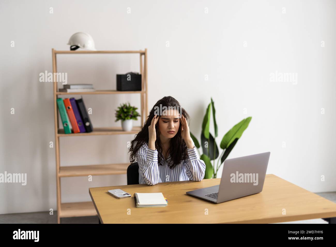 Young attractive woman at modern office desk, working on laptop ...