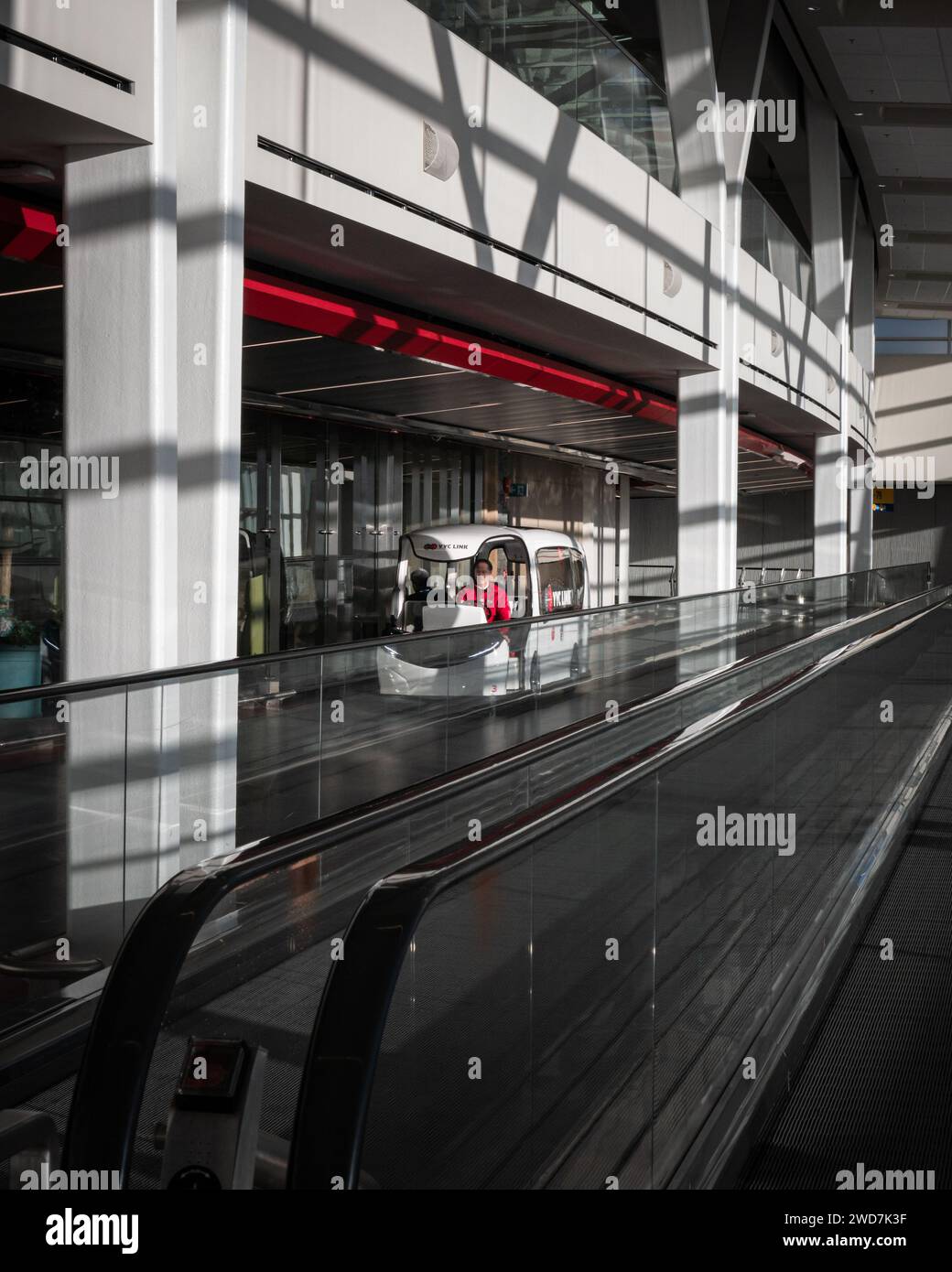 A bus arriving at an airport terminal, ready to pick up passengers ...