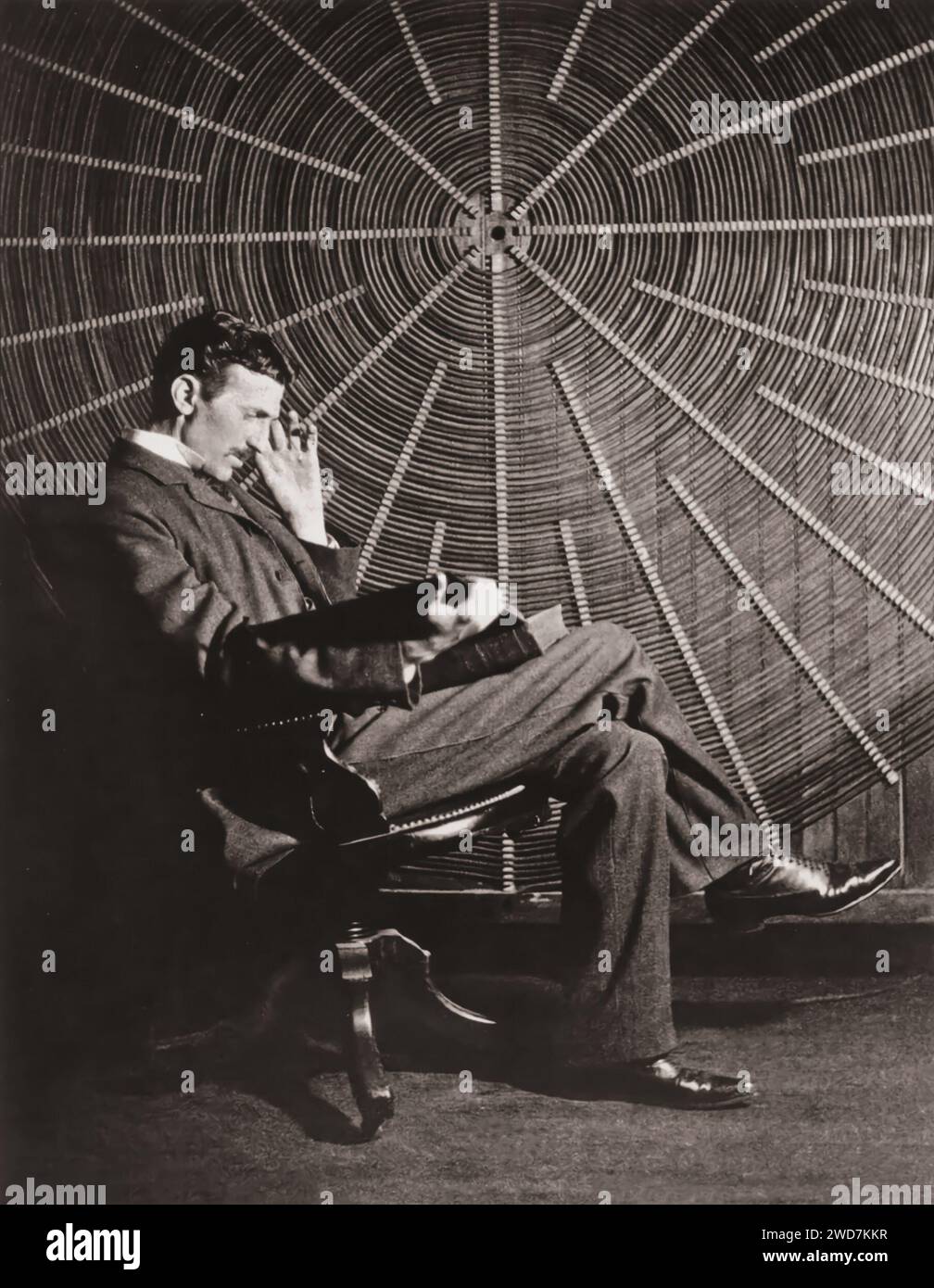 Nikola Tesla in front of the spiral coil of his high-voltage Tesla coil ...