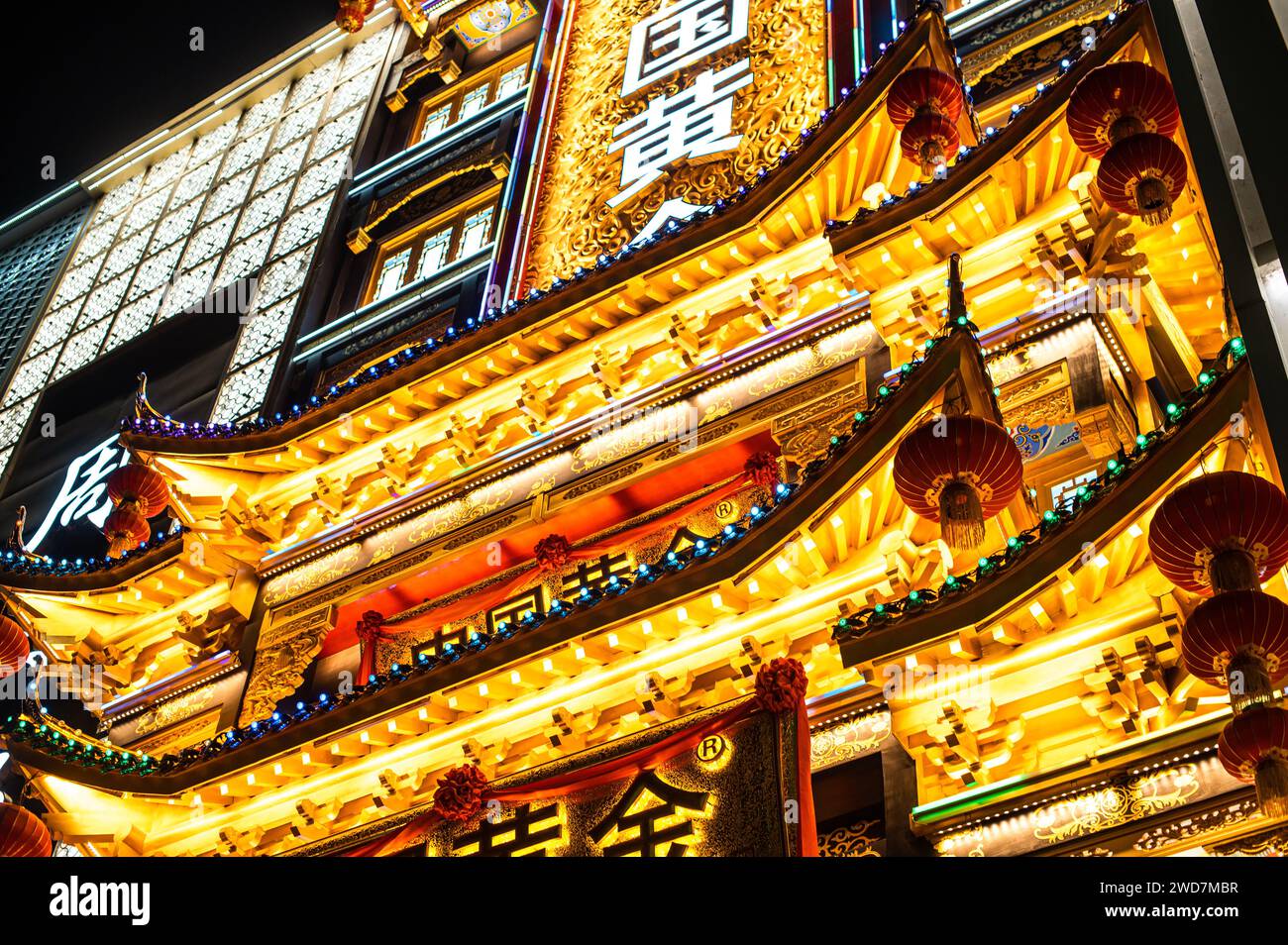 The nighttime view of a traditional Chinese building adorned with an ...