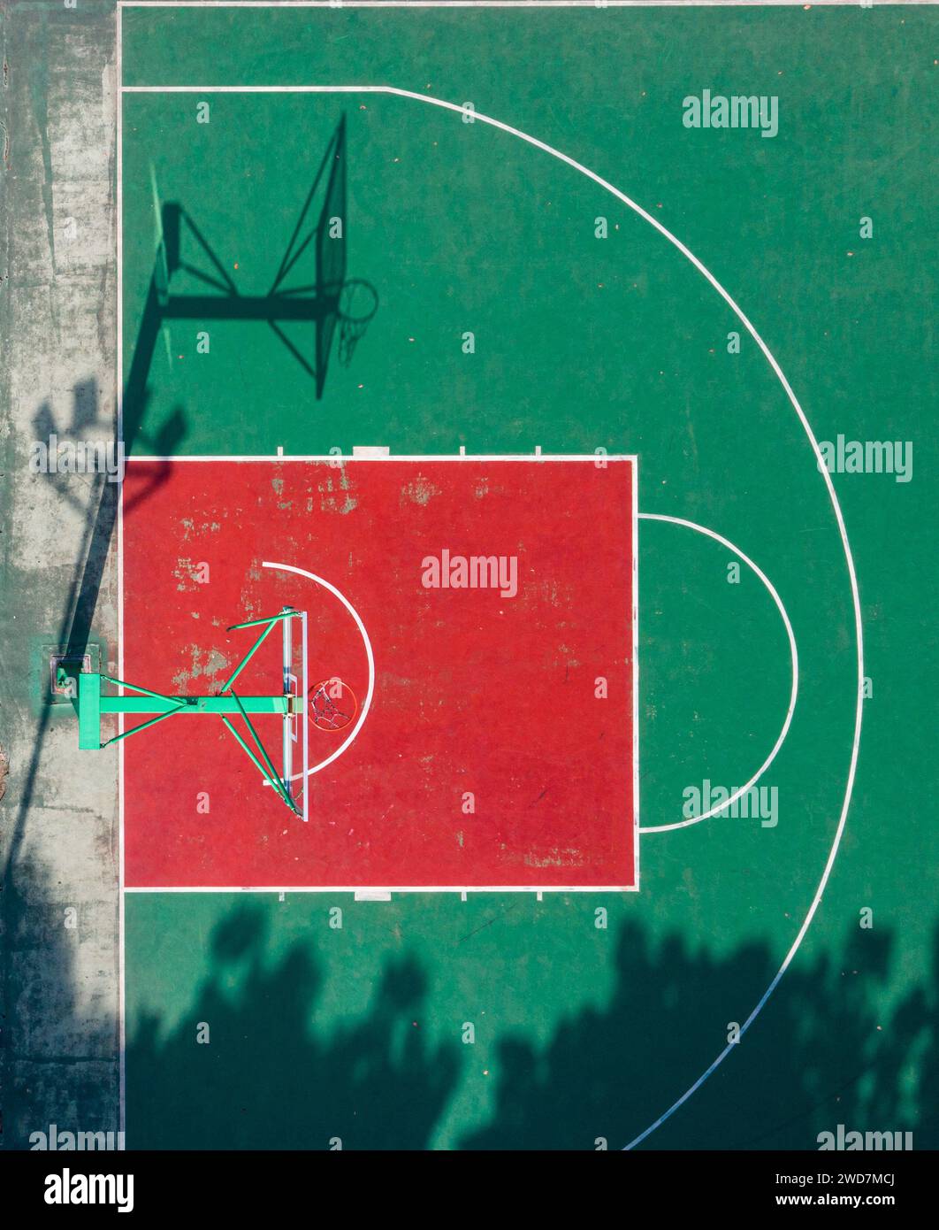 A vibrant basketball court with a vivid green floor and a contrasting ...