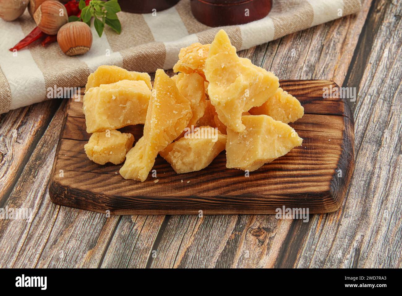 Crushed hard parmesan cheese pieces over board Stock Photo - Alamy