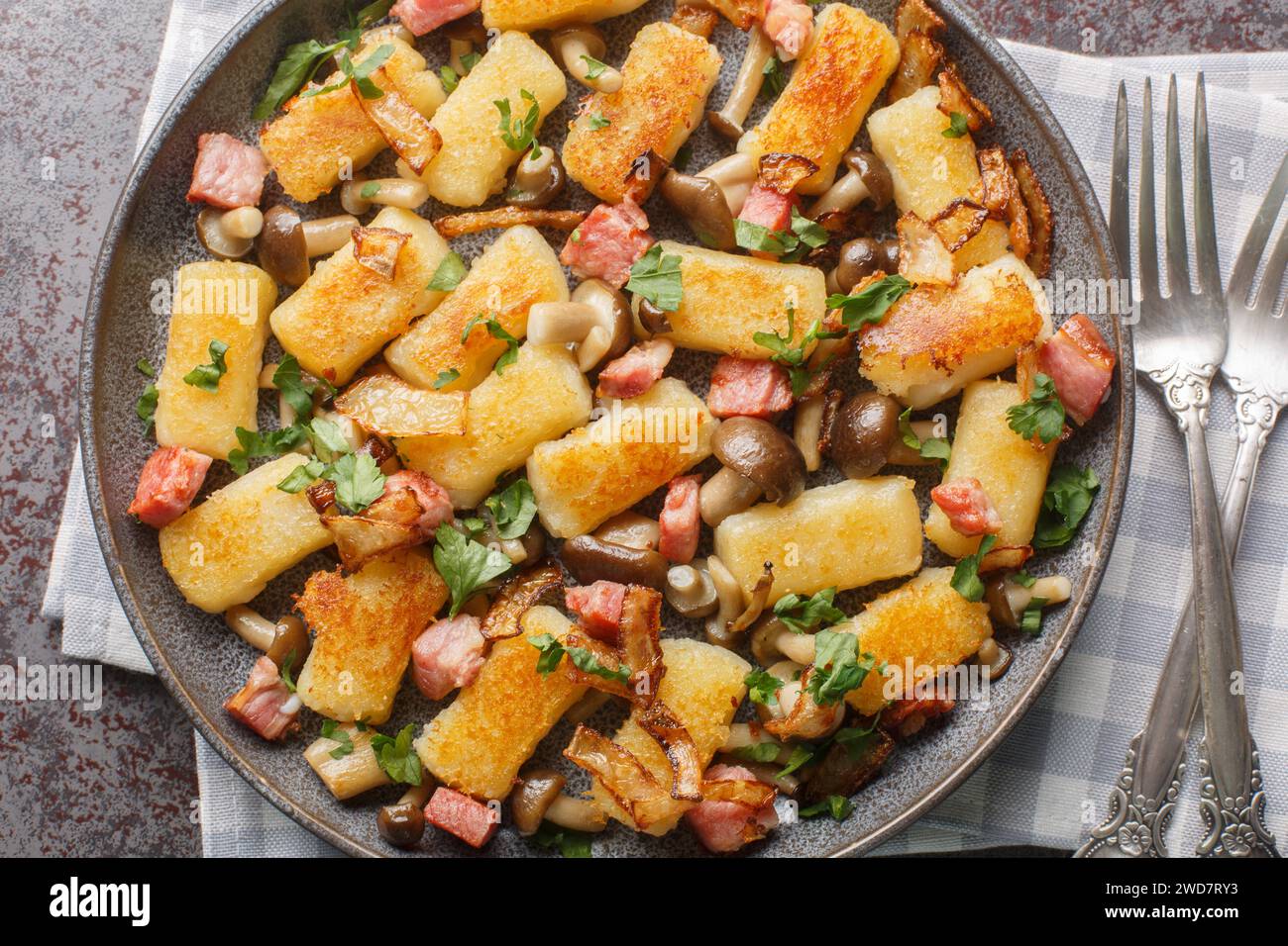 Homemade traditional Polish potato dumplings kopytka served with bacon ...