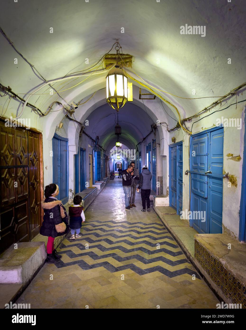 Children stand and wait inside the ancient covered souk de parfums in ...