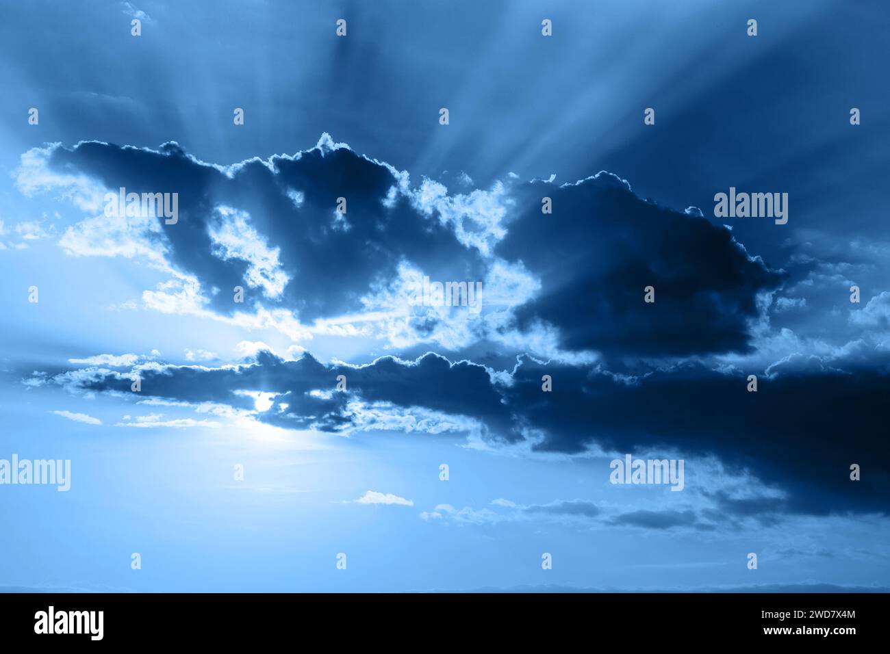 Color of the year 2020 classic blue. Rays of the sun through the clouds ...