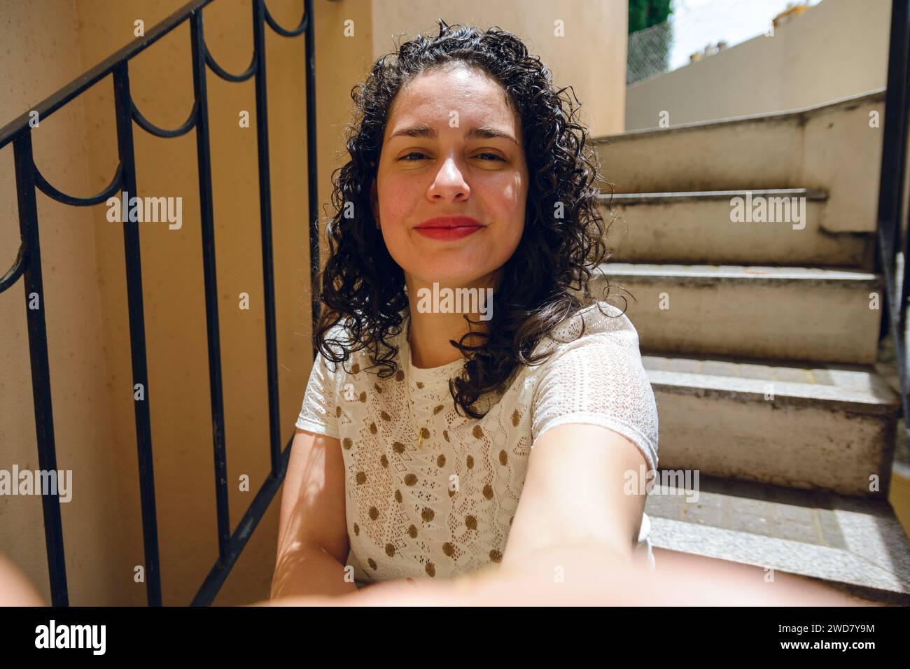 portrait of young Latin Venezuelan woman with curlers, makeup, and ...