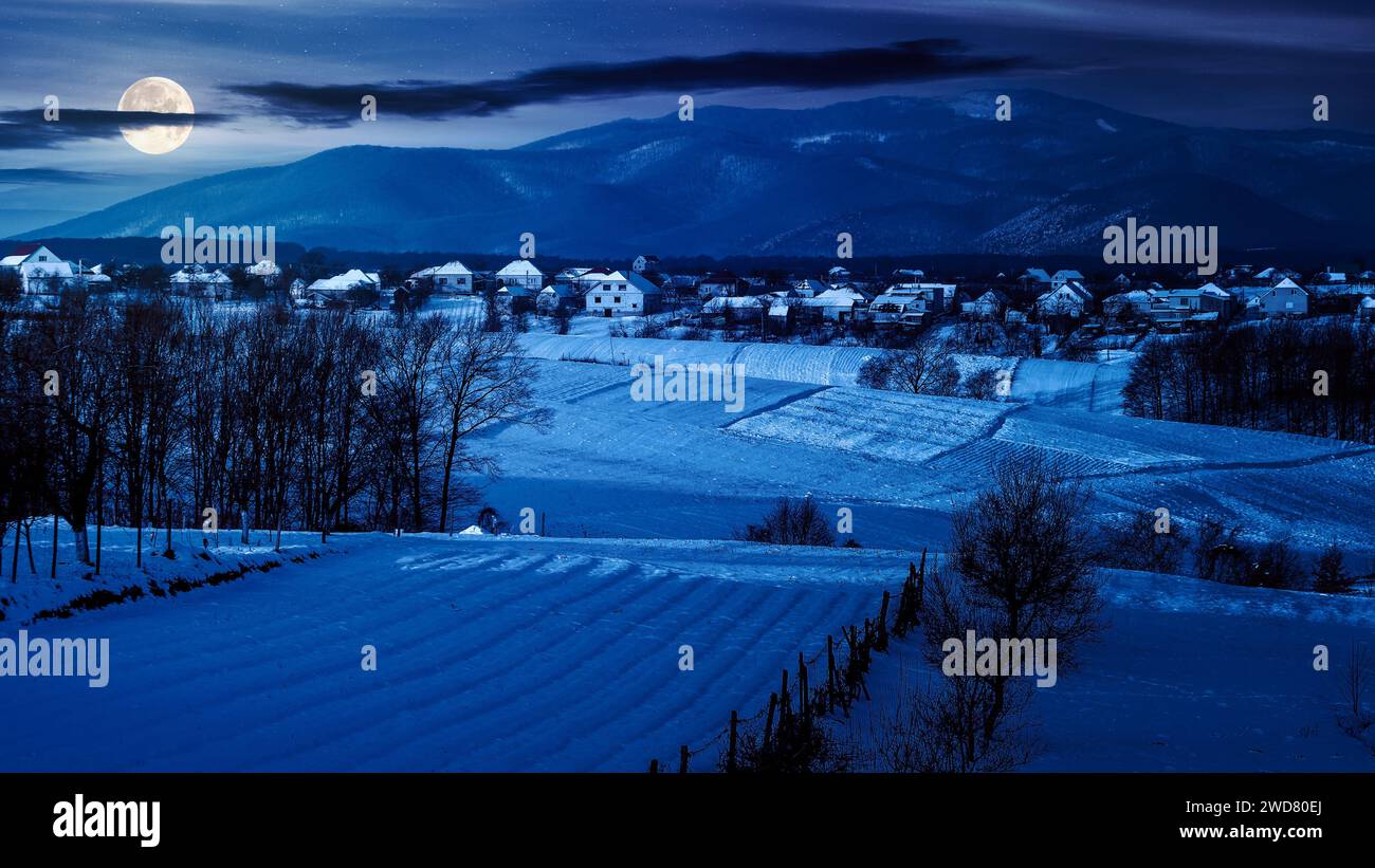 mountainous countryside scenery in winter at night. landscape with snow ...