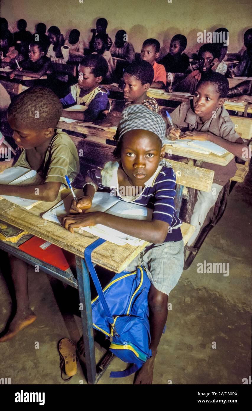 Ivory Coast, Portrait of a girl writing in a notebook at a village ...
