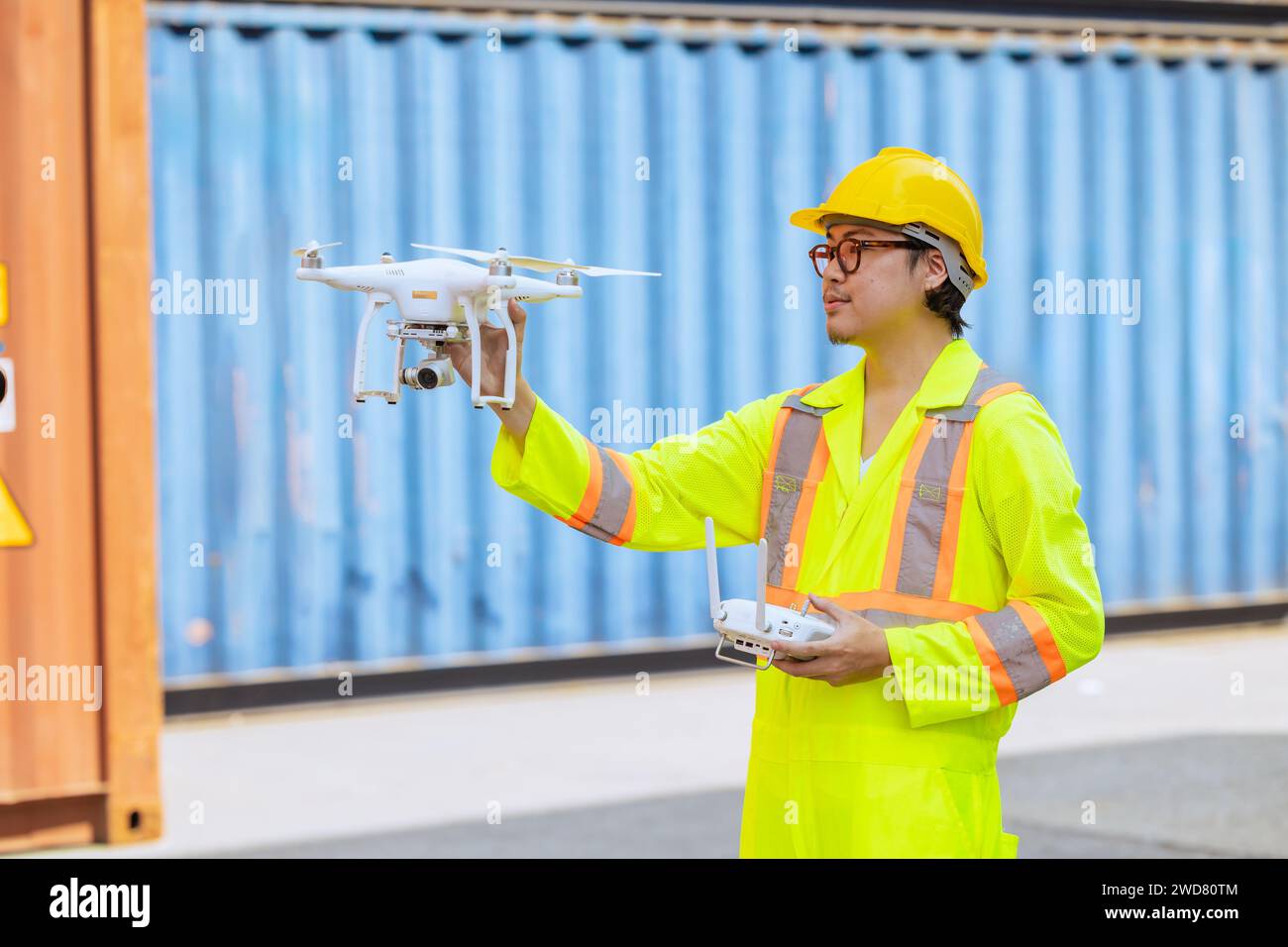 Staff worker using Drone aerial imaging system in port container yard ...