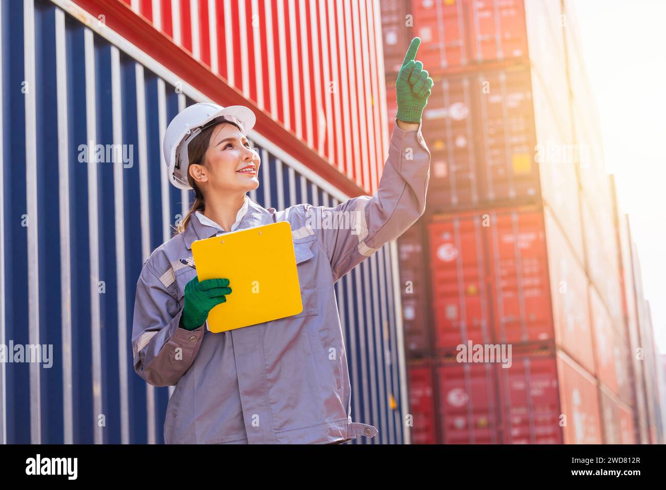 Asian women staff worker in port container yard cargo manager happy ...