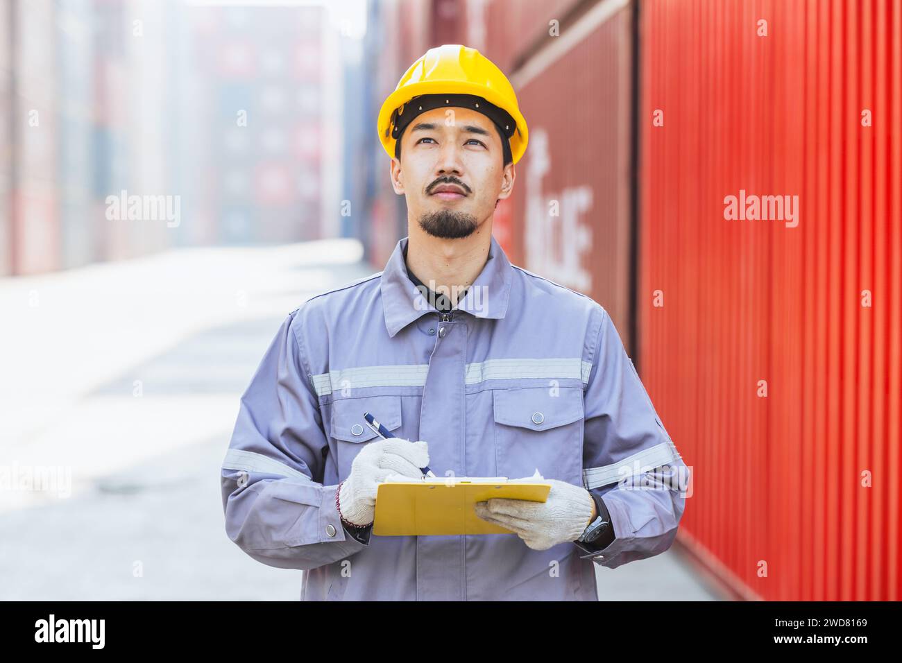Japanese male smart worker working in container port cargo. Japan ...