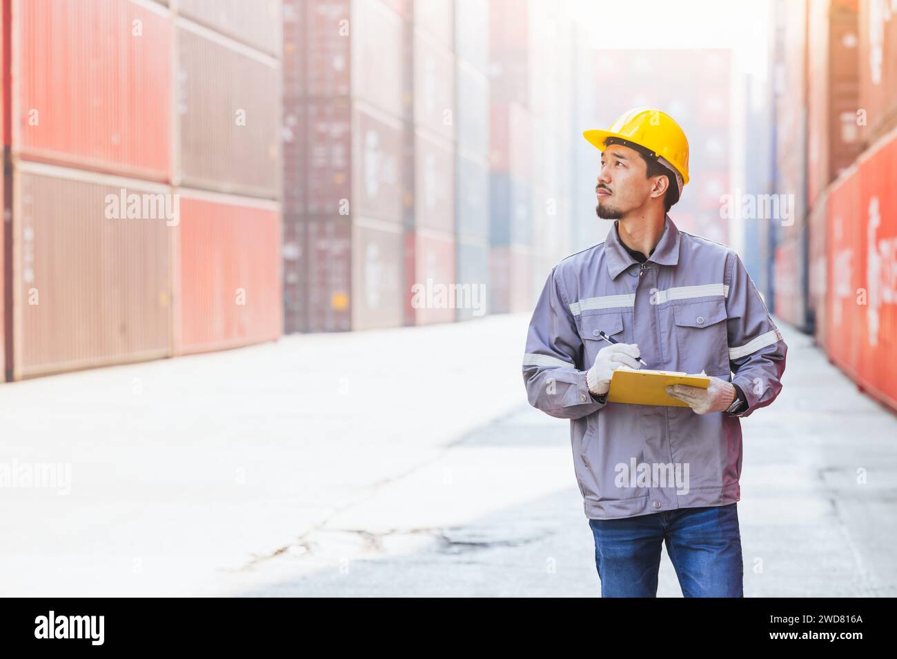 Japanese male smart worker working in container port cargo. Japan ...